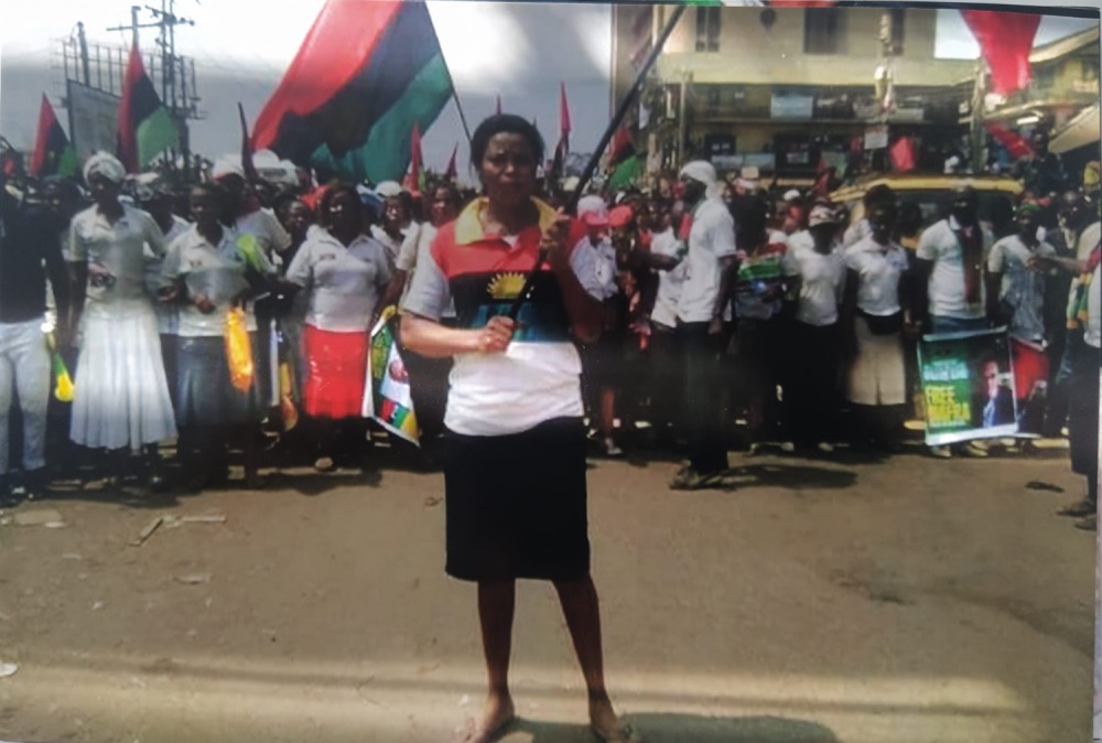IPOB Woman leader Nimphar Oluchi Ugorji holding a Biafran flag at a ...